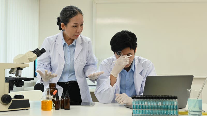 Professional Scientists Team Conducting Experiment in Modern Laboratory ... Professional Scientists Team Conducting Experiment in Modern Laboratory ...