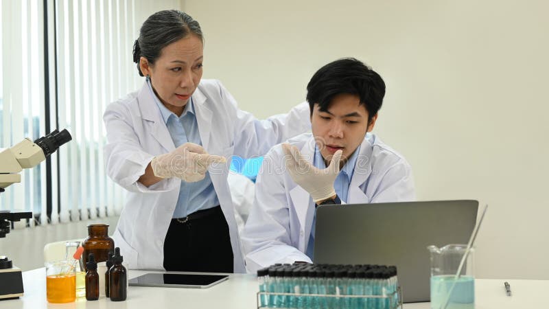 Professional Scientists Team Conducting Experiment in Modern Laboratory ... Professional Scientists Team Conducting Experiment in Modern Laboratory ...