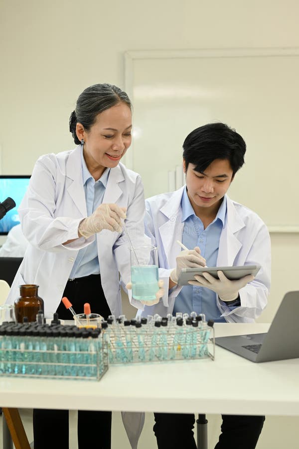 Professional Scientists Team Conducting Experiment in Modern Laboratory ... Professional Scientists Team Conducting Experiment in Modern Laboratory ...