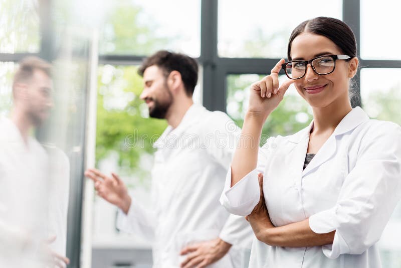 Professional Scientists in White Coats Smiling while Standing in ...