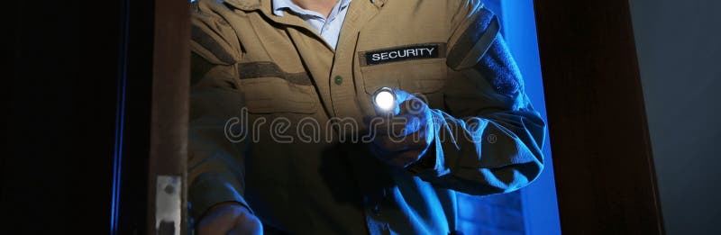 Professional Security Guard with Flashlight Checking Dark Room. Banner ...
