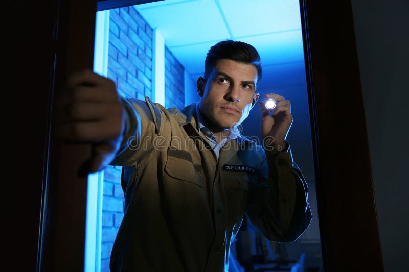 Professional Security Guard with Flashlight Checking Room Stock Image ...