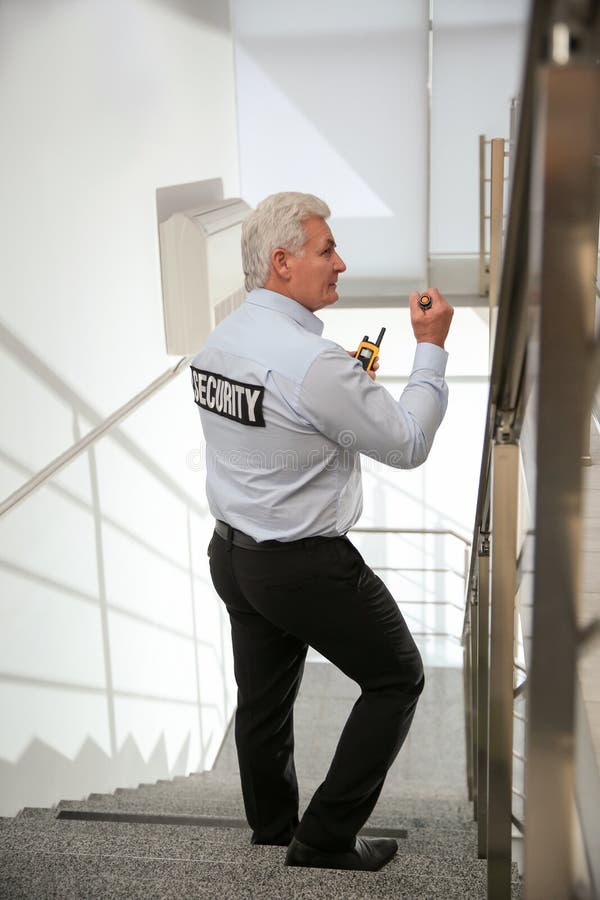 Professional Security Guard with Flashlight on Stairs Stock Photo ...