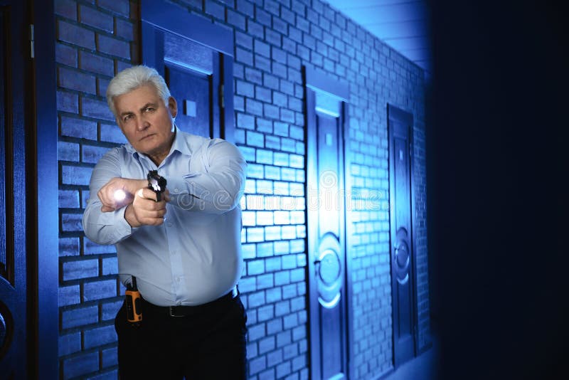 Professional Security Guard with Gun and Flashlight Checking Hallway ...