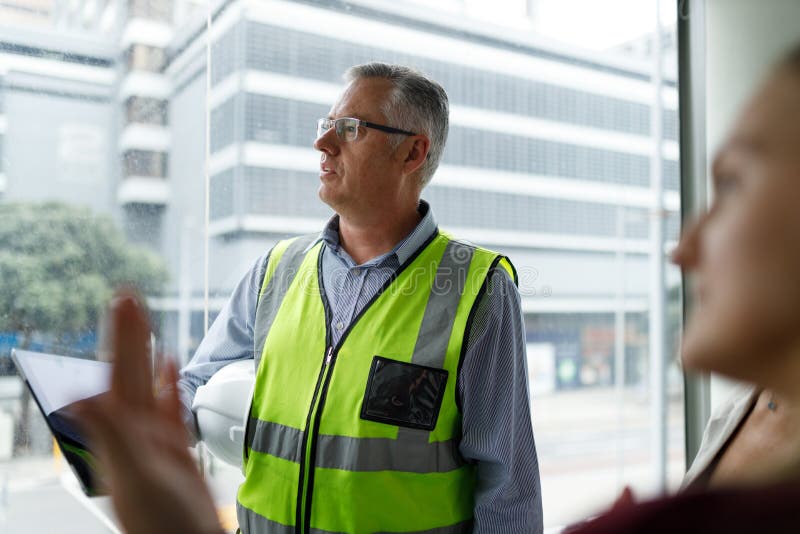 Professional Senior Engineer Builder Showing Clients Around in the New ...