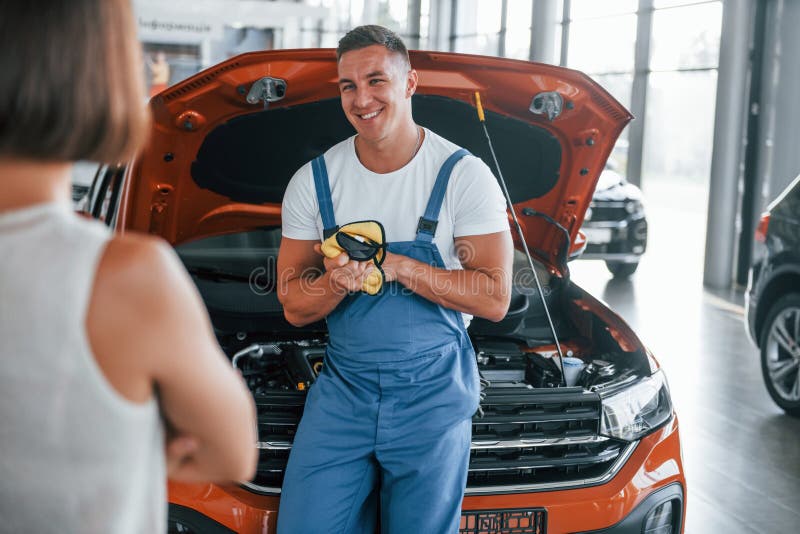 Professional Service. Man in Uniform is Repairing Broken Automobile ...