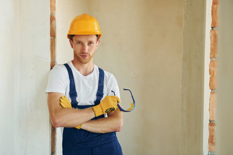 Professional Service. Young Man Working in Uniform at Construction at ...