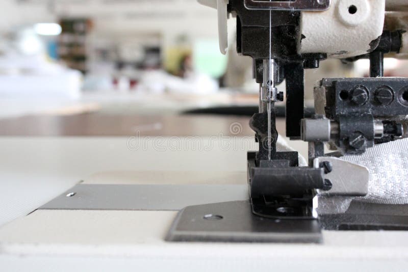 Professional Sewing Machine Overlock in the Workshop. Equipment for ...