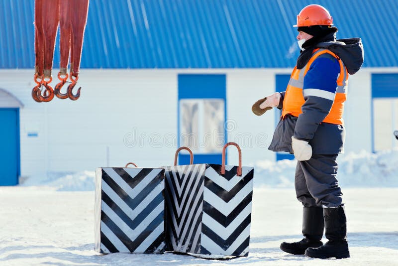Professional Slinger in Construction Helmet at Factory Unloads Cargo ...