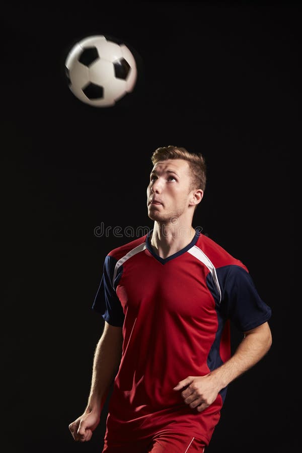 Professional Soccer Player Heading Ball in Studio Stock Image - Image ...