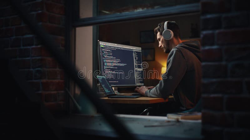 Software Developer Working On A Desktop Computer With Two Green Screen Chromakey Display Screens