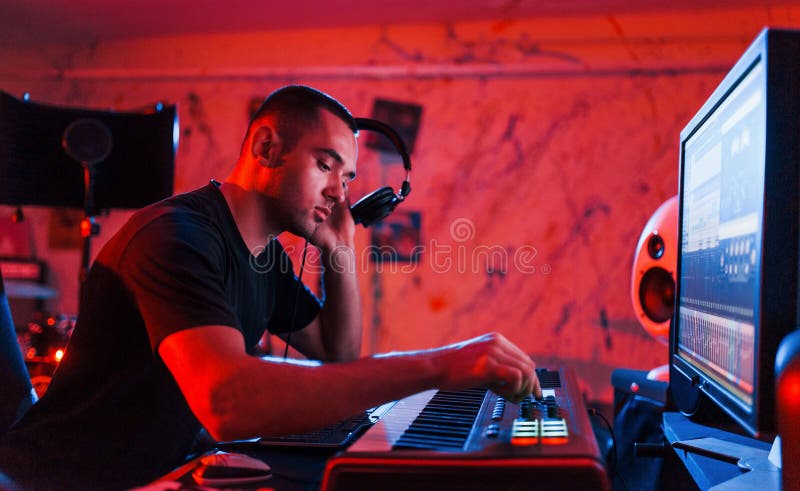 Professional Sound Engineer Working and Mixing Music Indoors in the ...