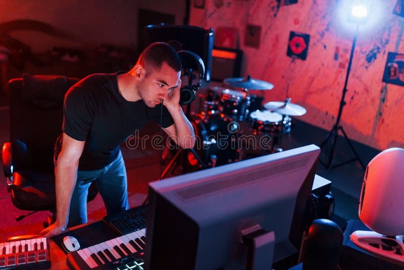 Professional Sound Engineer Working and Mixing Music Indoors in the ...