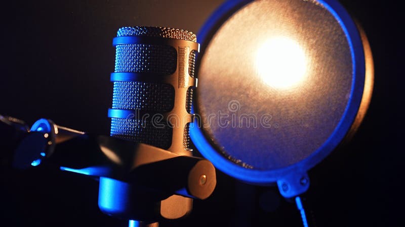 Professional Studio Microphone with Pop Filter in Dramatic Lighting ...