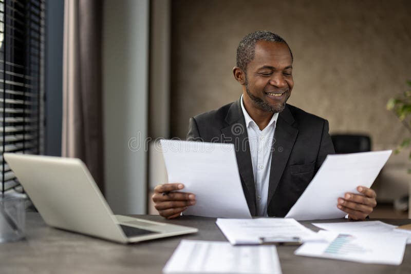 Professional Reviewing Documents at a Modern Workspace Stock Photo ...
