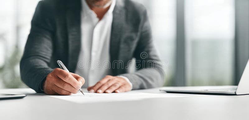 A Professional in a Suit is Meticulously Writing on a Document, Focused ...