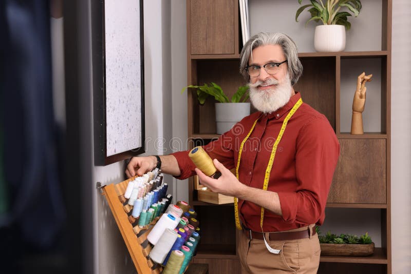 Professional Tailor Choosing Thread Near Stand in Workshop Stock Image ...
