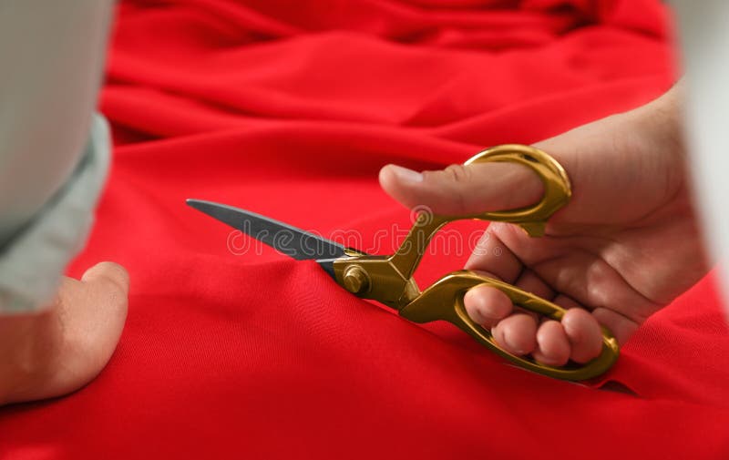 Professional Tailor Cutting Red Fabric with Scissors in Workshop Stock ...