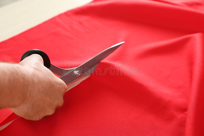 Professional Tailor Cutting Red Fabric with Scissors in Workshop, Stock ...