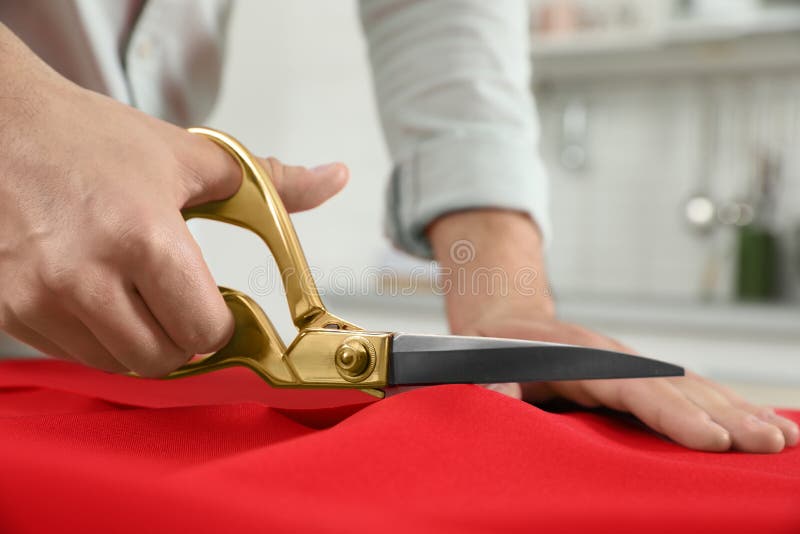 Professional Tailor Cutting Red Fabric with Scissors in Workshop Stock ...