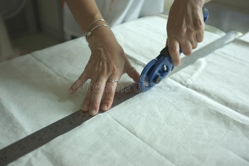 Professional Tailor Cutting White Fabric with Cutter in Workshop ...