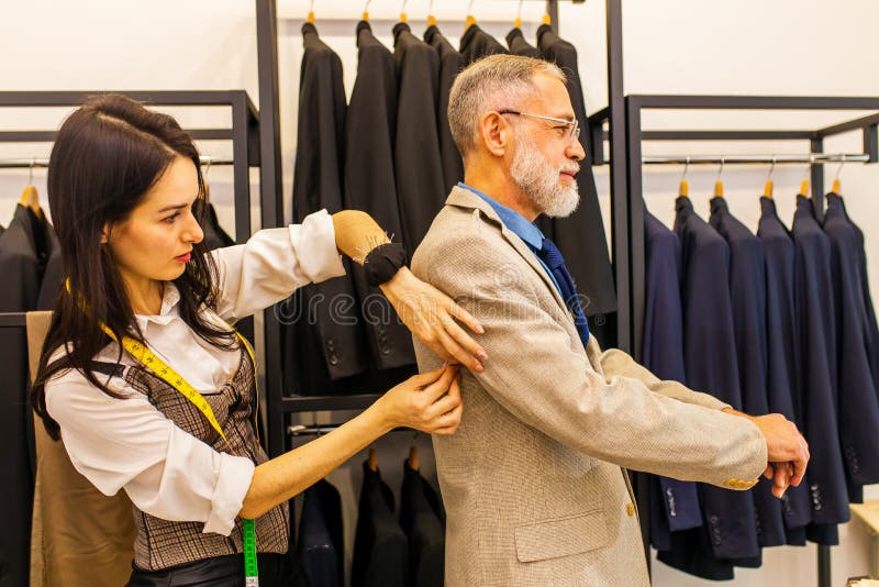 A Professional Tailor Woman Trying on a Tailor-made Suit for an Elderly ...