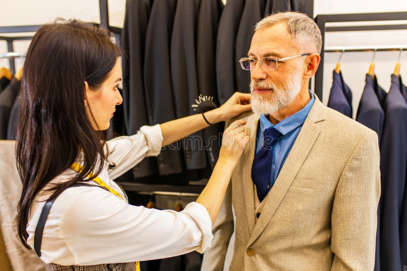A Professional Tailor Woman Trying on a Tailor-made Suit for an Elderly ...