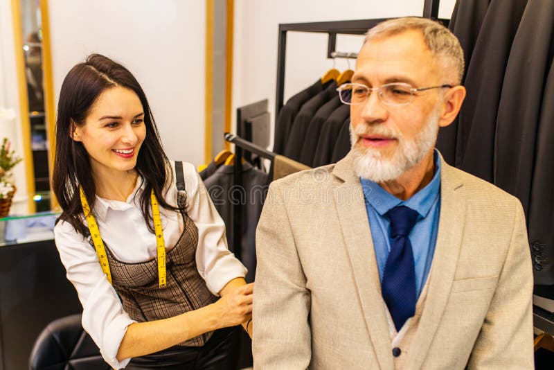 A Professional Tailor Woman Trying on a Tailor-made Suit for an Elderly ...