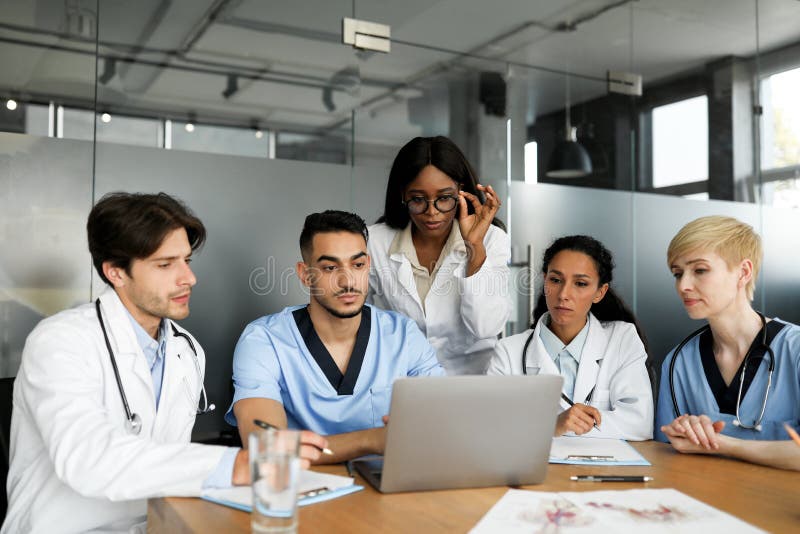 Professional Team of Doctors Looking at Notebook Screen Stock Image ...