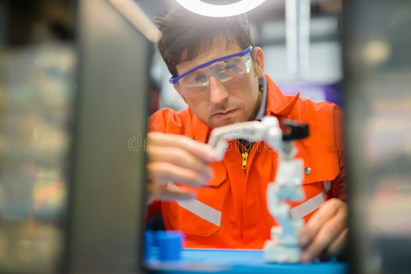 Professional Technician Checking and Repairing Parts of Robotic Machine ...