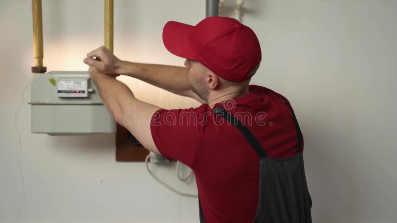 Skilled Technician Performs Gas Meter Maintenance in a Residential ...
