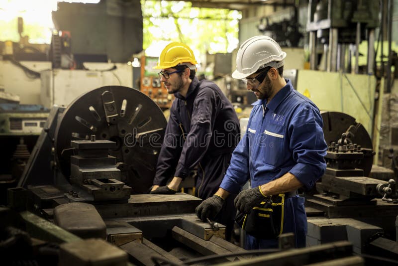 Professional Technicians and Engineers Wearing Protective Clothing are ...