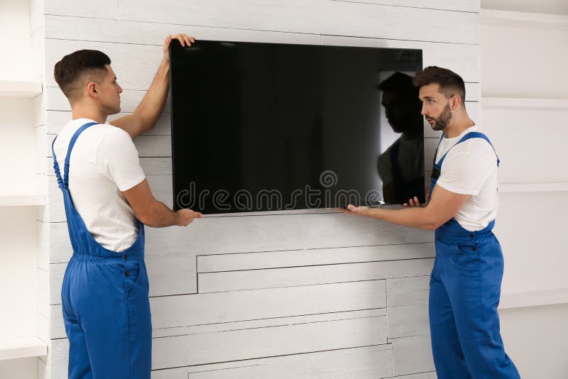 Professional Technicians Installing Modern Flat Screen TV on Wall ...
