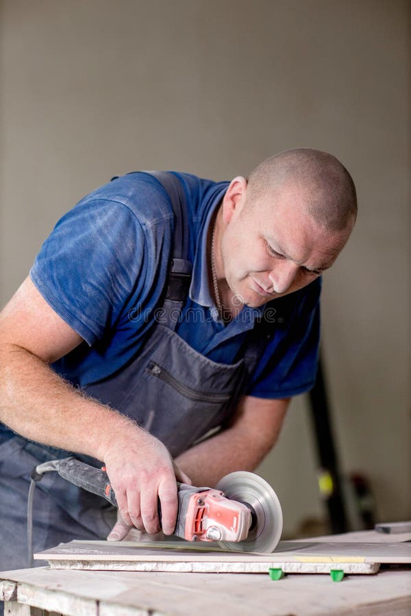 Professional Tiler and Ceramic Tiles Worker on Construction Site Stock ...