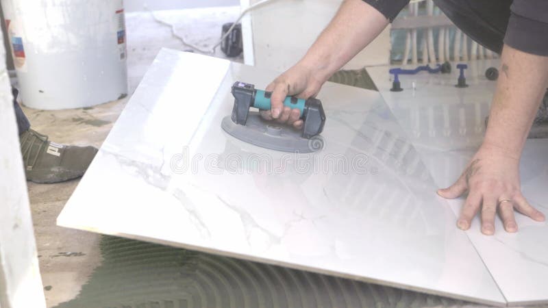 Construction Worker Placing Floor Tile Using Suction Cup Tool Stock ...