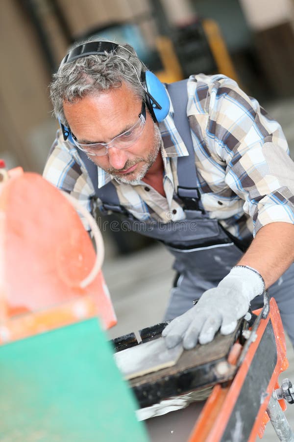 Professional tiler at work stock image. Image of indoors - 55517777