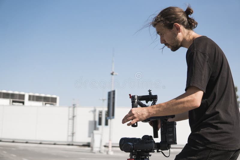 Professional Videographer Holding Camera on 3-axis Gimbal. Videographer ...