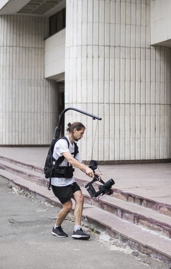 Professional Videographer Holding Camera on 3-axis Gimbal Which Mounted ...