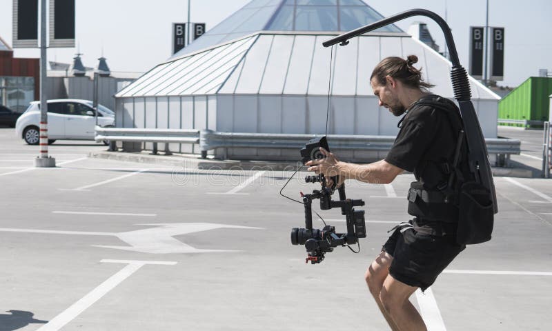 Professional Videographer Holding Camera on 3-axis Gimbal Which Mounted ...