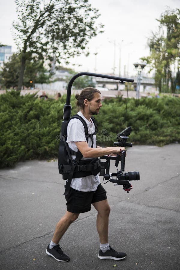 Professional Videographer Holding Camera on 3-axis Gimbal Which Mounted ...