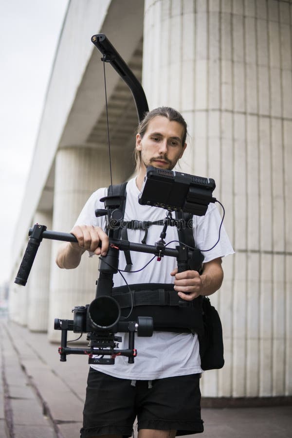 Professional Videographer Holding Camera on 3-axis Gimbal Which Mounted ...