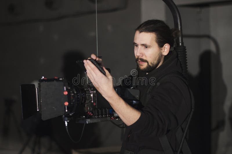 Professional Videographer Holding Camera Mounted on Easy Rig ...