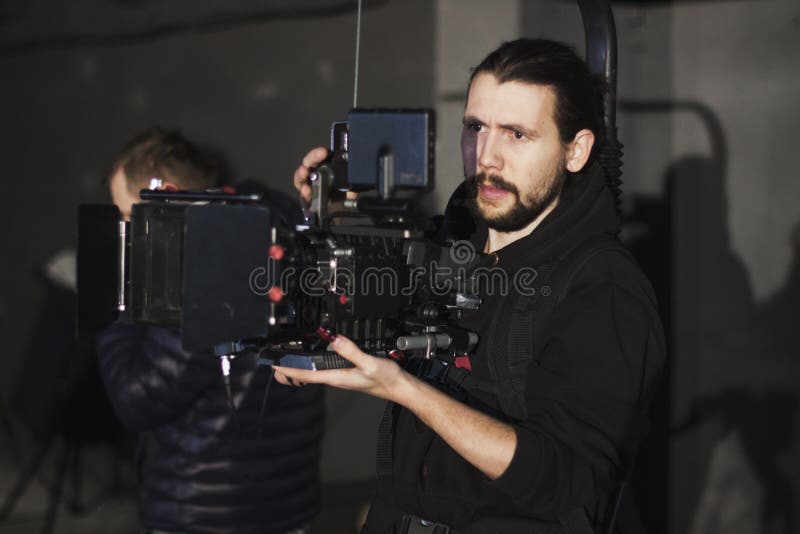 Professional Videographer Holding Camera Mounted on Easy Rig ...