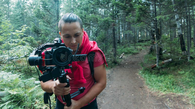 Professional Videographer Holding DSLR Camera on 3-axis Gimbal ...