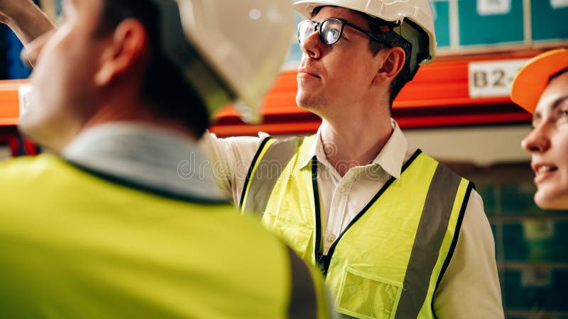 Professional Warehouse Workers with Safety Vest Talking and Discussing ...