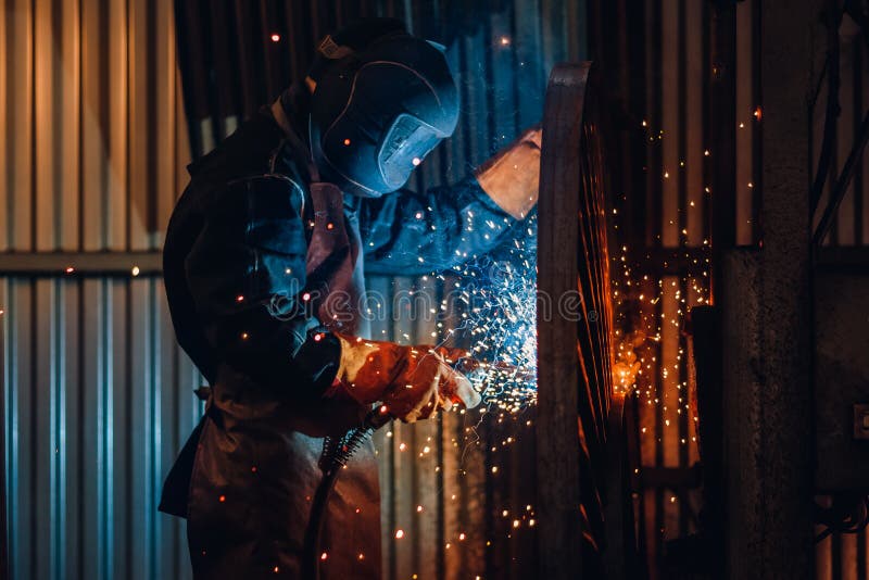 Professional Welder Performs Welding Work on Metal in Protective Mask ...