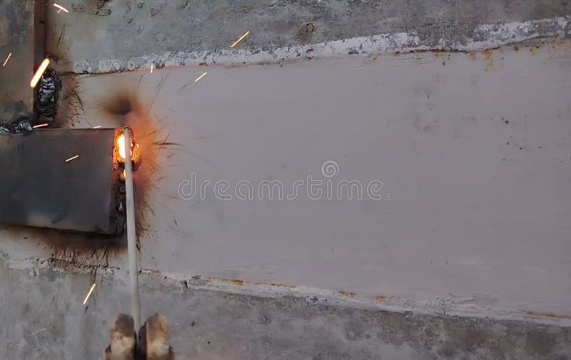 A Professional Welder Performs Welding Work on Metal Structures. Stock ...