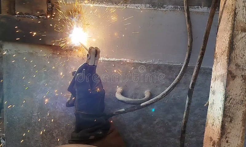 A Professional Welder Performs Welding Work on Metal Structures. Stock ...