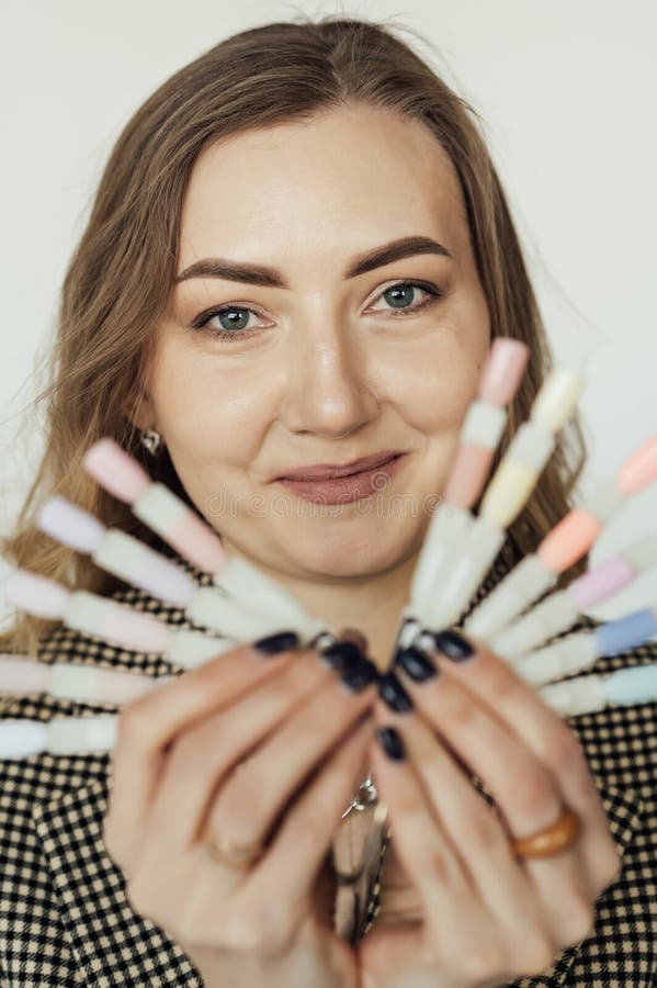 Professional Woman Master of Manicure Posing with Samples of Nails. the ...