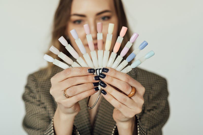 Professional Woman Master of Manicure Posing with Samples of Nails. the ...